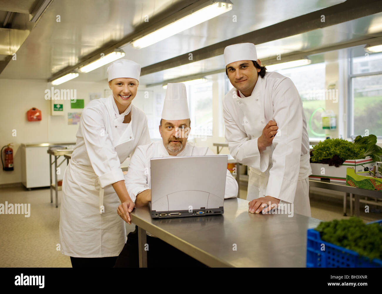 Three chefs looking at the camera Stock Photo - Alamy