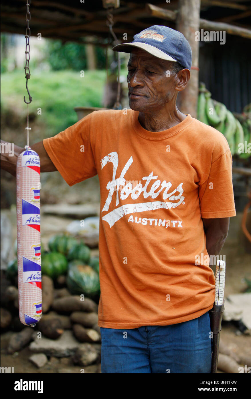 Rural Dominican man with a machete in a second-hand Hooters t-shirt ...
