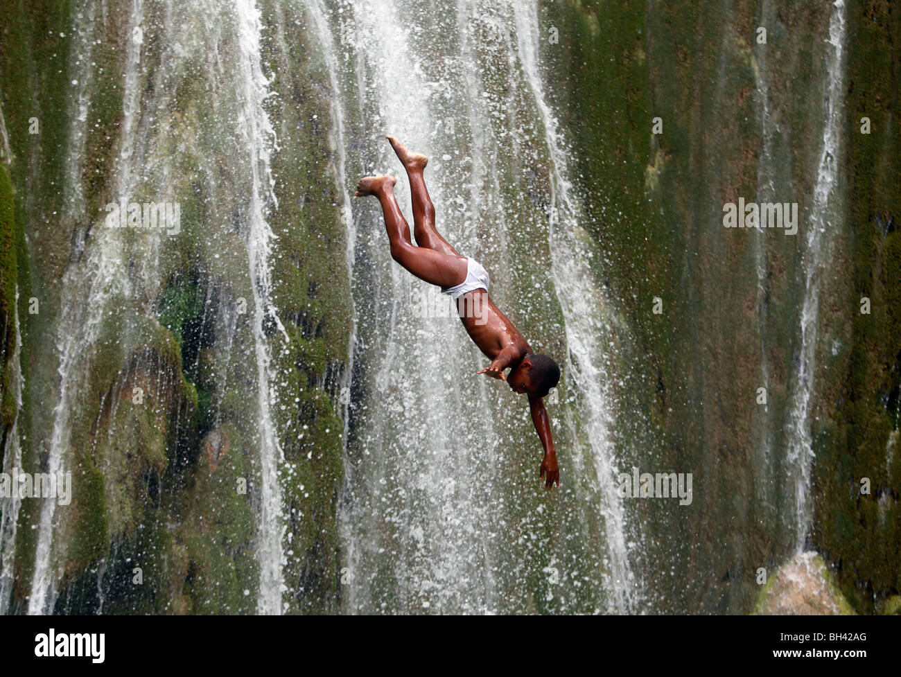 A Dominican boy dives at El Limon waterfall, Samana peninsula ...