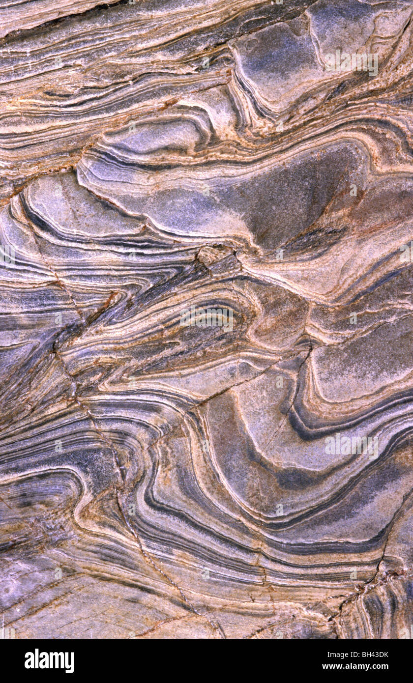 Abstract image of a section of rock showing coloured patterned strata ...
