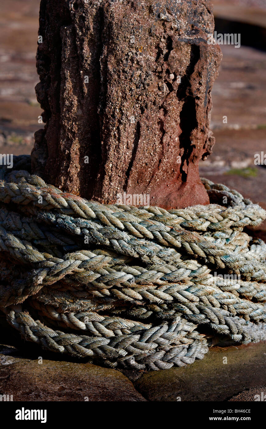 Rope wound round old stone capstan in Pennan harbour Stock Photo - Alamy