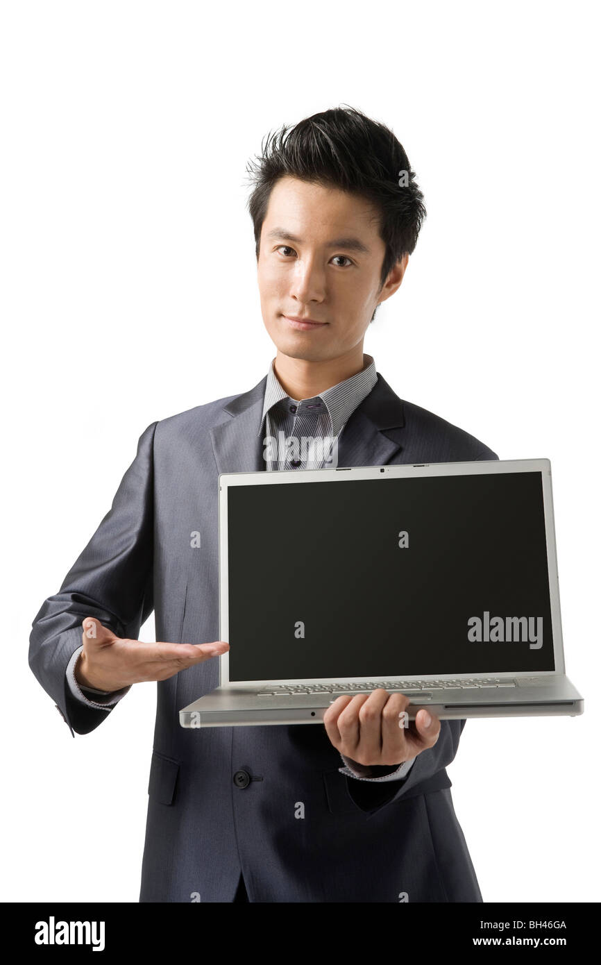 Businessman showing computer Stock Photo - Alamy