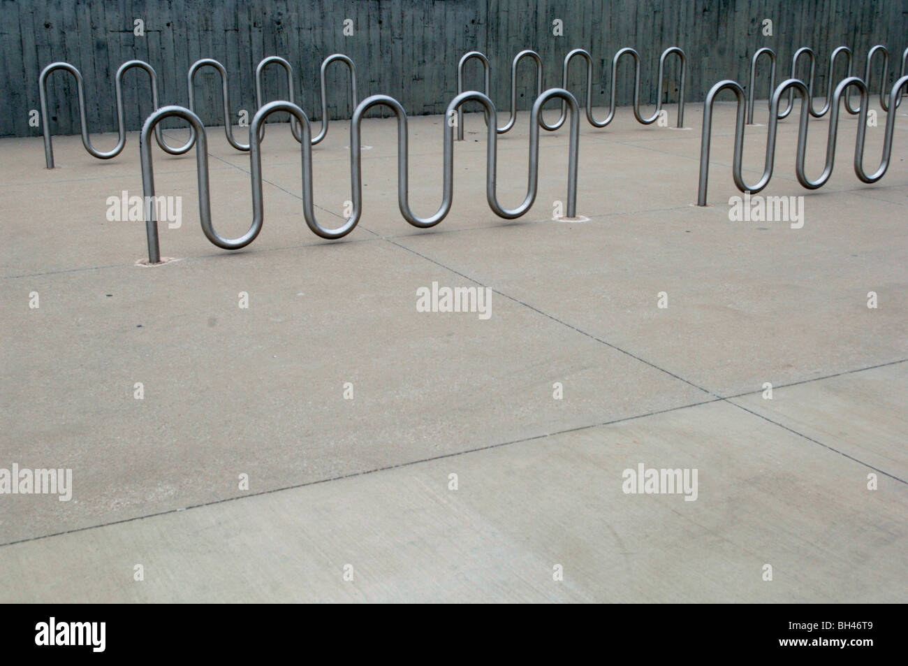 The curves and contours of a metal bike rack in a school yard creates ...