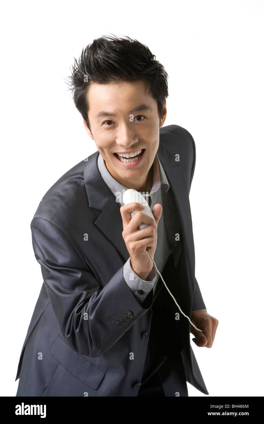 Cheerful businessman singing karaoke hi-res stock photography and ...