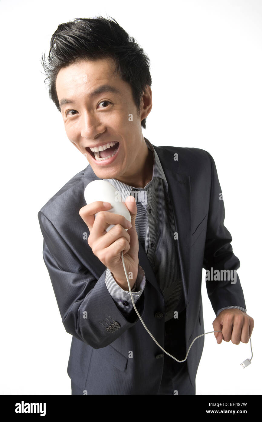 Cheerful businessman singing karaoke hi-res stock photography and ...
