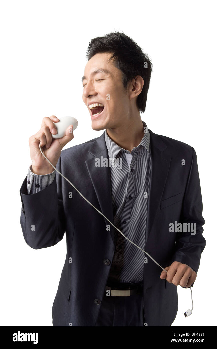Cheerful businessman singing karaoke hi-res stock photography and ...