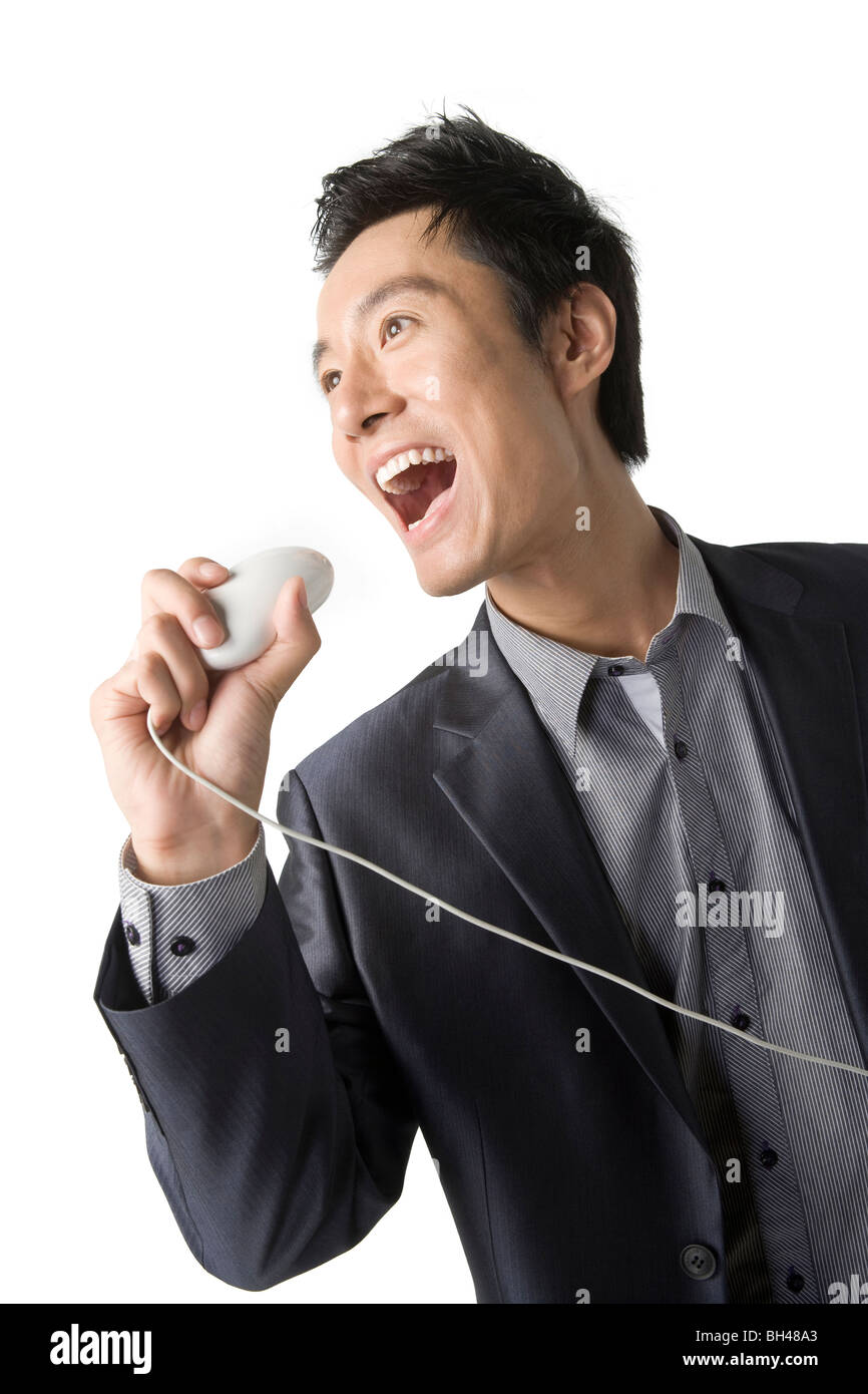 Cheerful businessman singing karaoke hi-res stock photography and ...