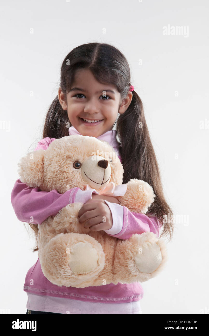 Girl holding a teddy bear Stock Photo - Alamy