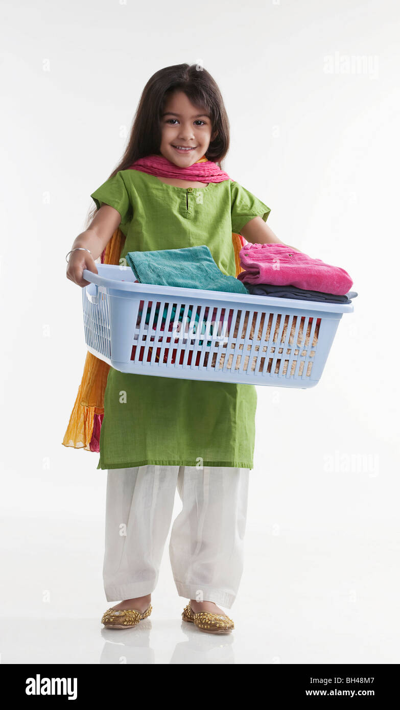 Indian kid carrying laundry basket hi-res stock photography and images ...