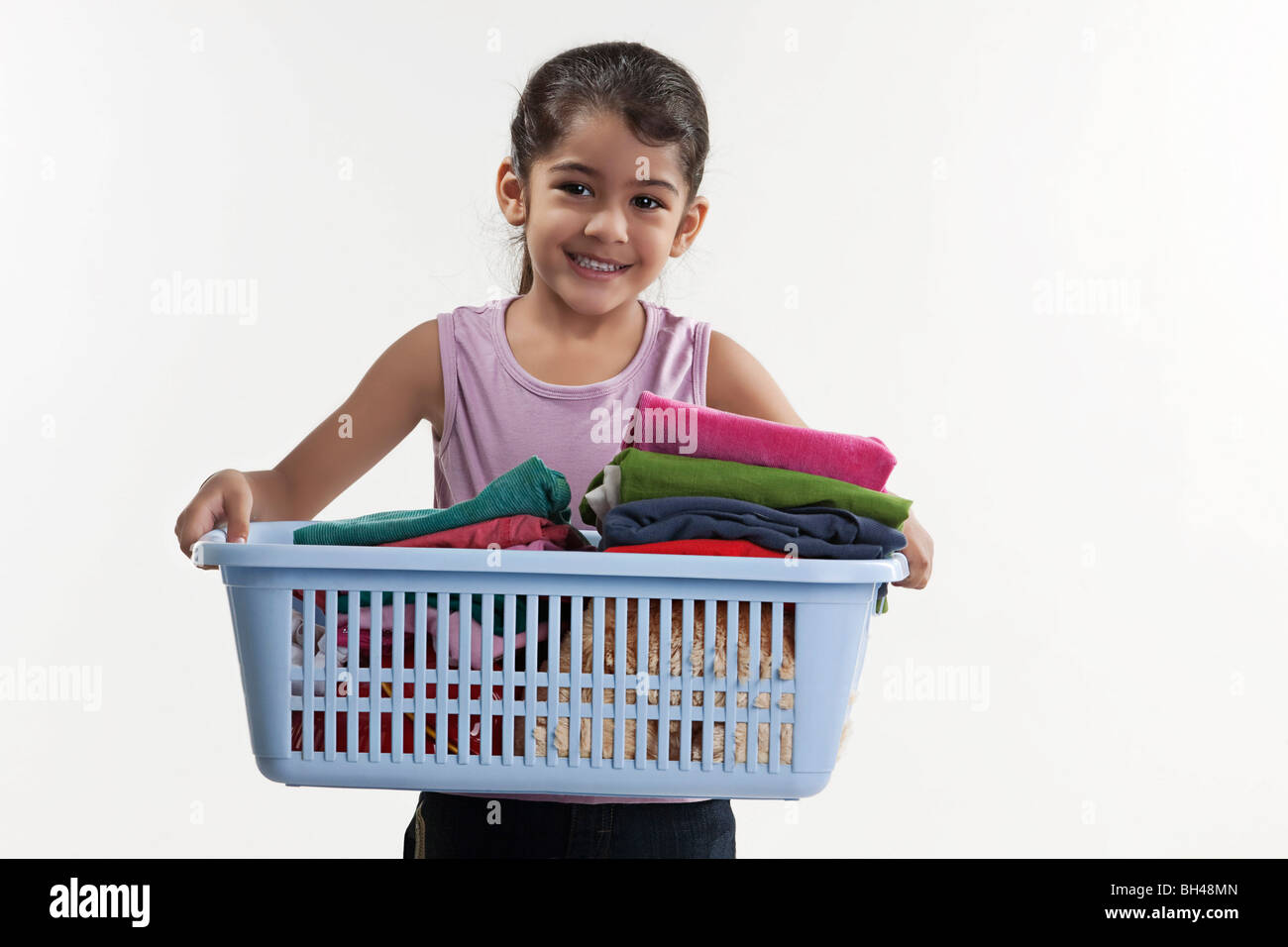 Girl carrying laundry basket Stock Photo - Alamy
