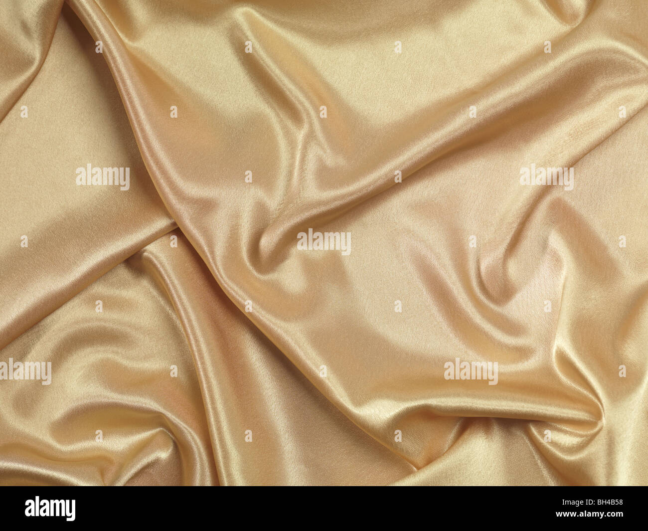 Golden shiny silky fabric background Stock Photo - Alamy