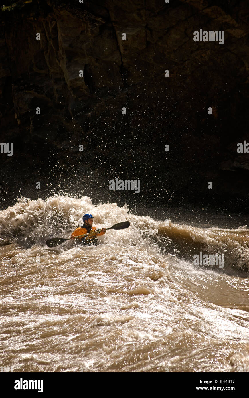 A kayaker encounters big whitewater during a rafting trip in Western ...