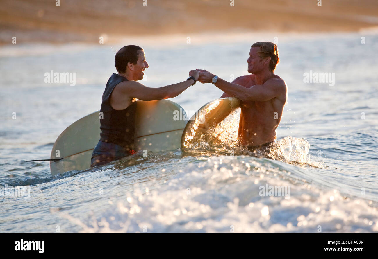 Two men share a bonding moment while surfing at T-Tree Point, Noosa ...