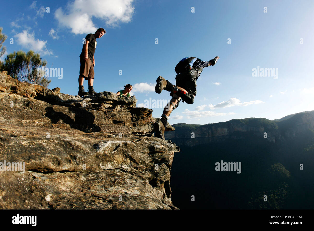 A BASE jumper performs a front flip off a cliff in the Blue Mountains ...