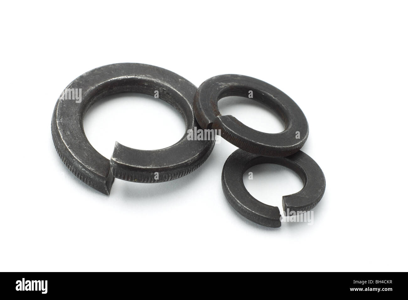 Three used metal washers on white background Stock Photo - Alamy