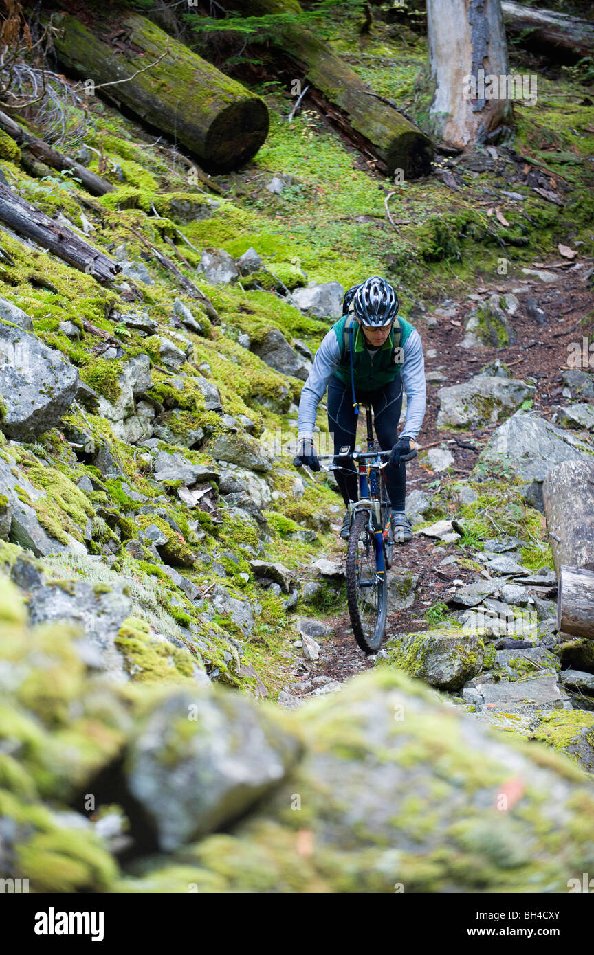 A mountain biker rides a rocky, single track trail in northern Idaho ...