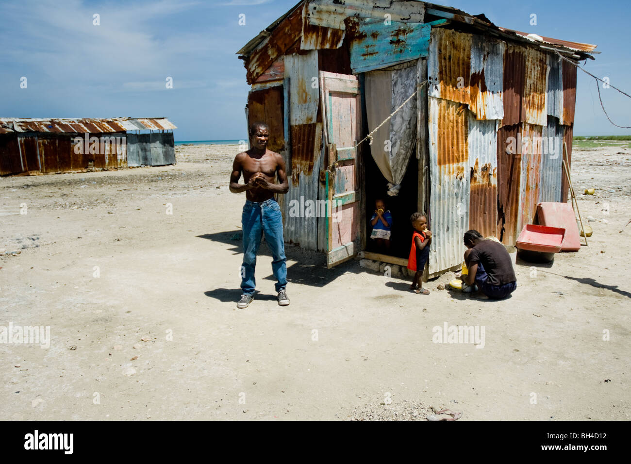 A Haitian family in front of a shack in the slum of Cité Soleil Stock ...