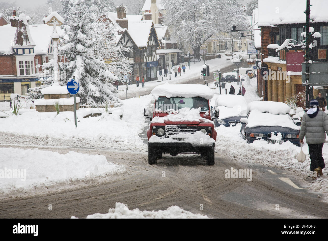 Cars make their way up a snow covered Haslemere High Street, Surrey ...