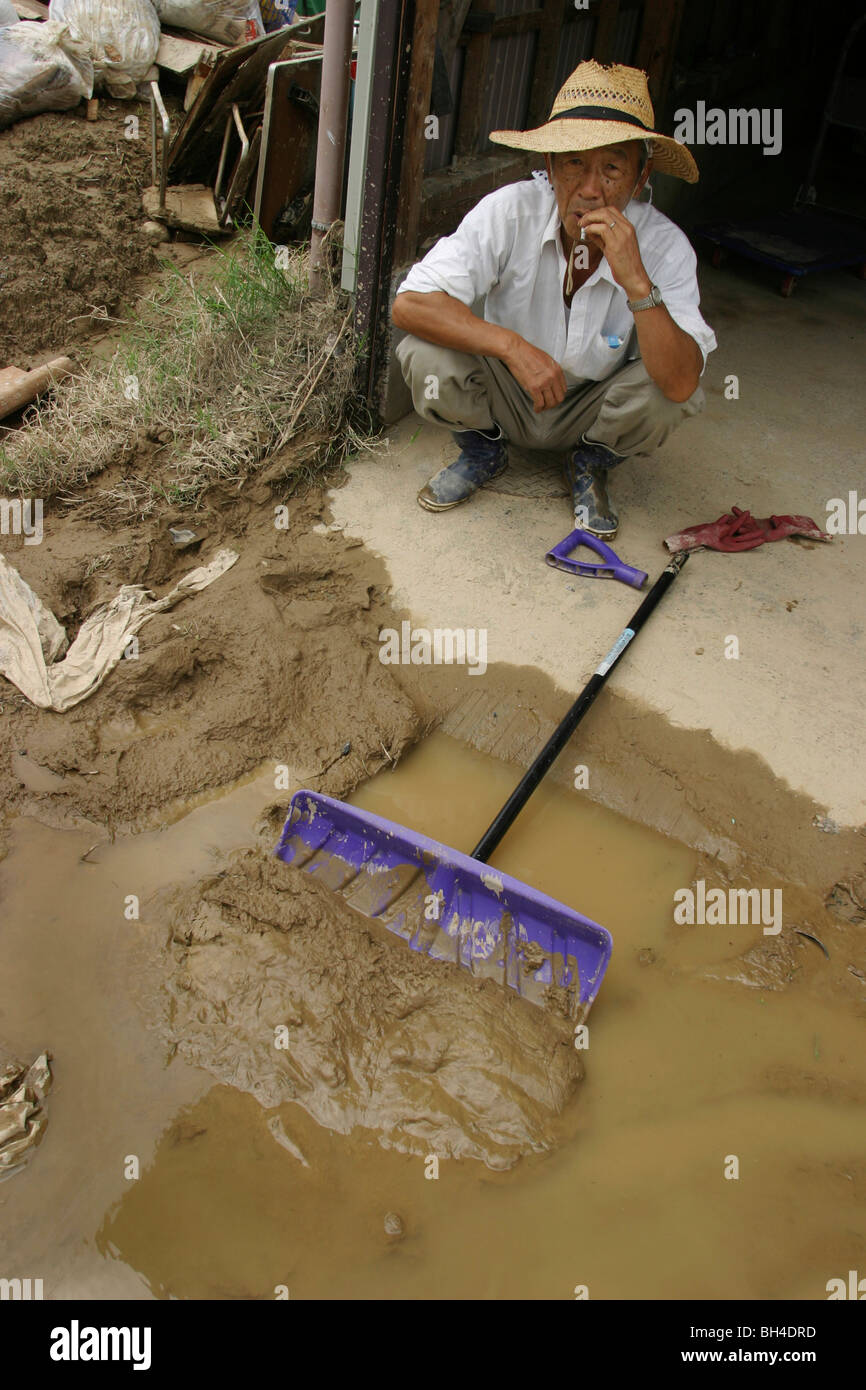 Residents of Sanjo city, clean up after a week of torrential rains ...
