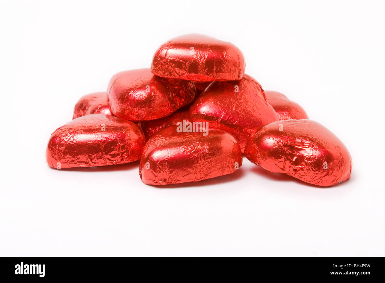 Red foil wrapped chocolate hearts for valentine's day Stock Photo - Alamy