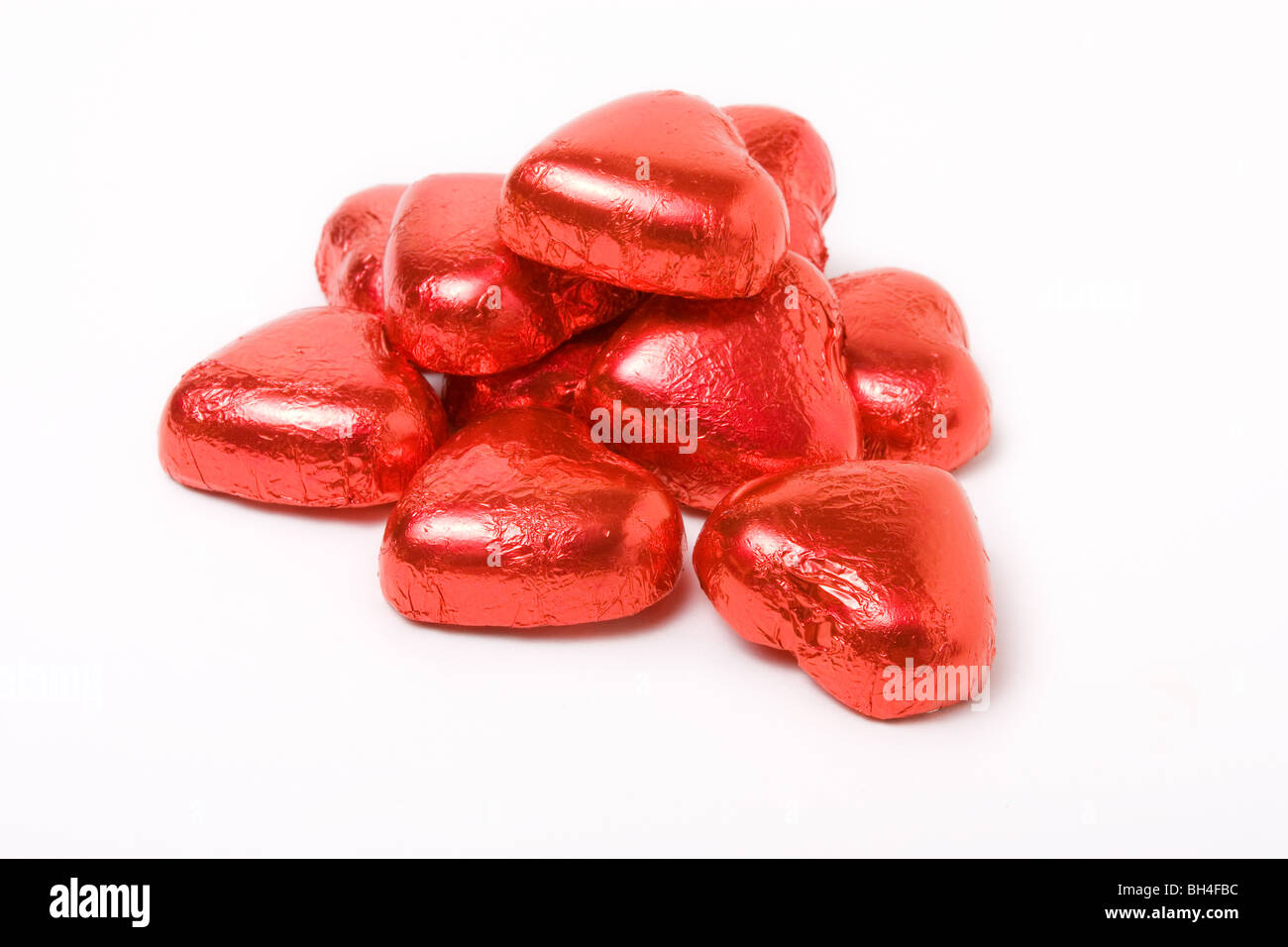 Red foil wrapped chocolate hearts for valentine's day Stock Photo - Alamy