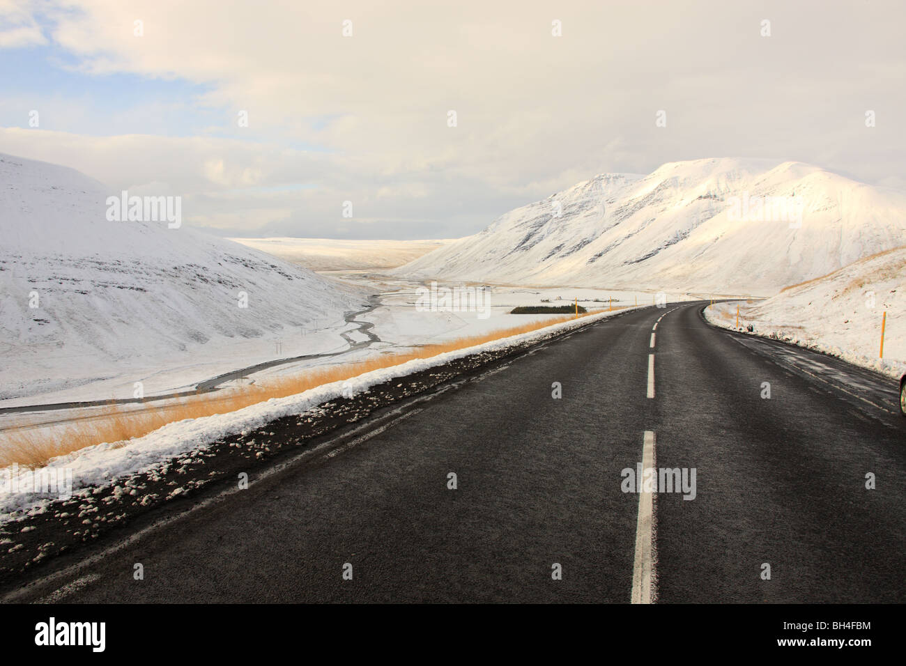Road through a snowy mountain pass, central Iceland Stock Photo - Alamy