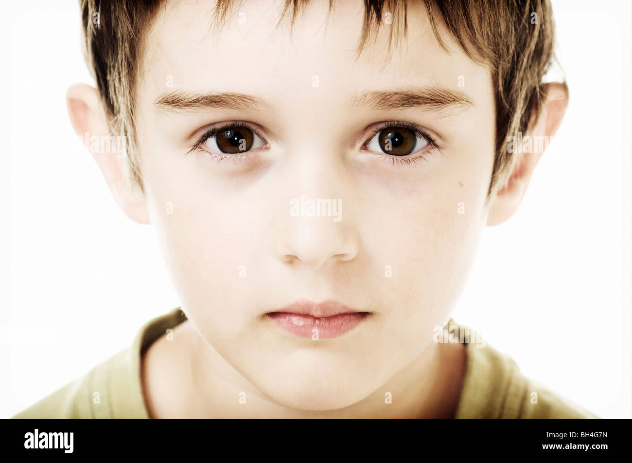 Close-up of serious-looking boy on white background, Otterburn Park ...