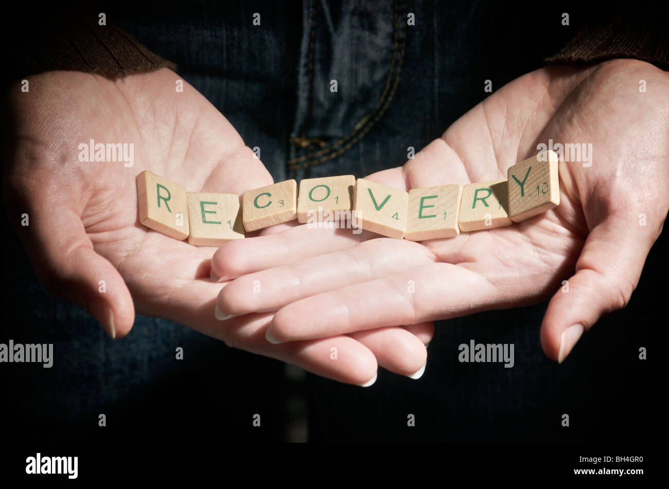 Hands holding scrabble tiles that spell recovery, Otterburn Park ...