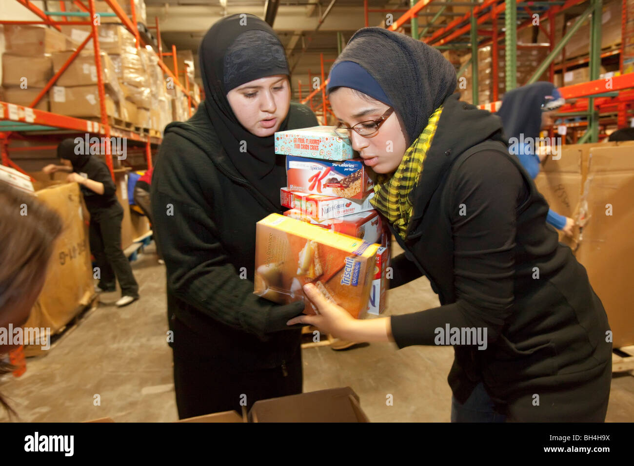 Volunteers Pack Food at Community Food Bank Stock Photo - Alamy