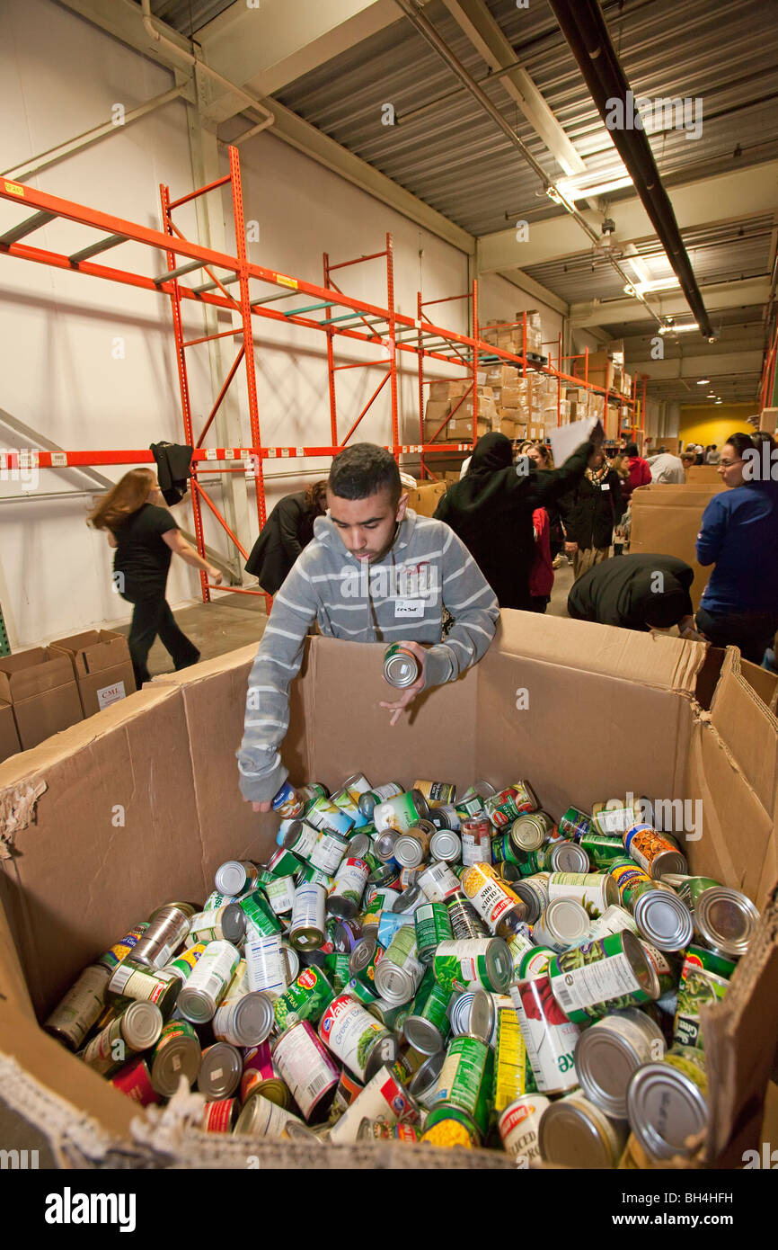 Volunteers Pack Food at Community Food Bank Stock Photo - Alamy