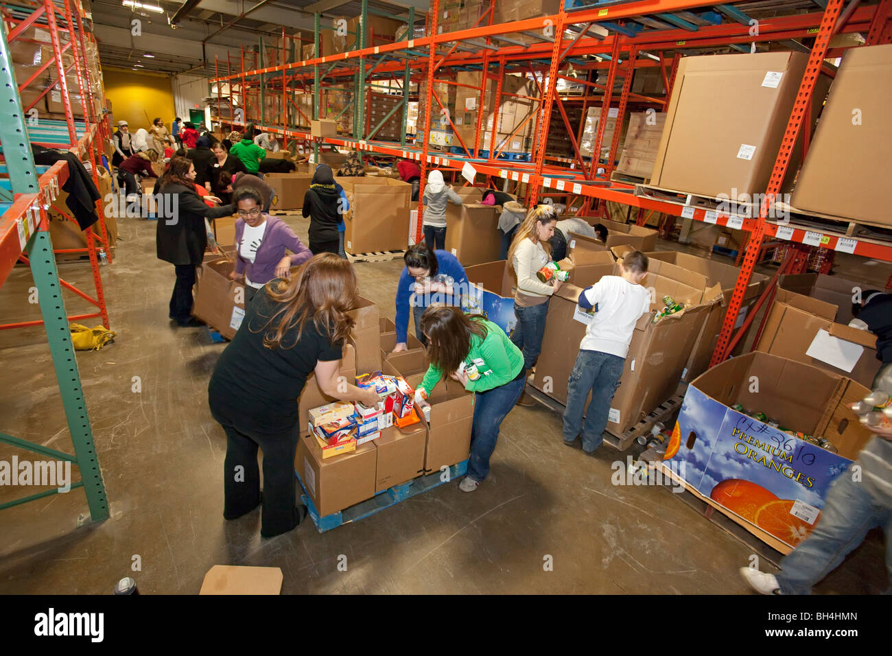 Volunteers Pack Food at Community Food Bank Stock Photo - Alamy