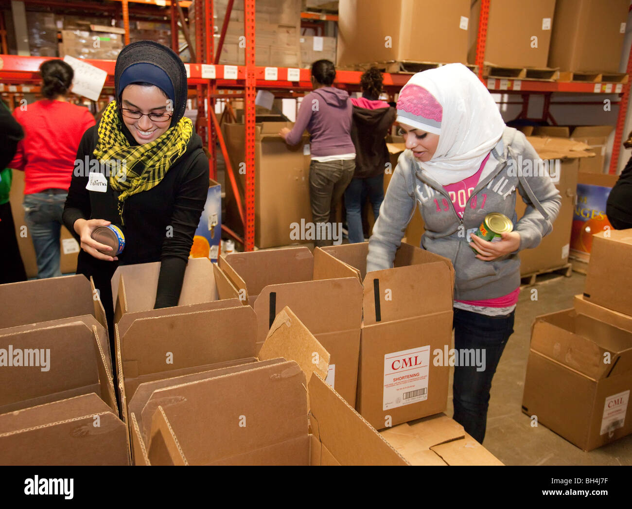 Volunteers Pack Food at Community Food Bank Stock Photo - Alamy