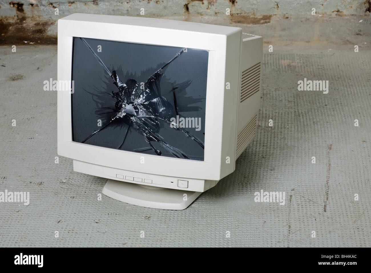 Smashed computer monitor in the cellar Stock Photo - Alamy