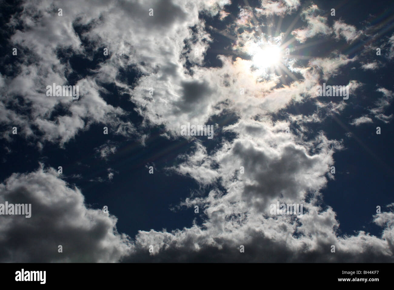 Sun shining through clouds Stock Photo - Alamy