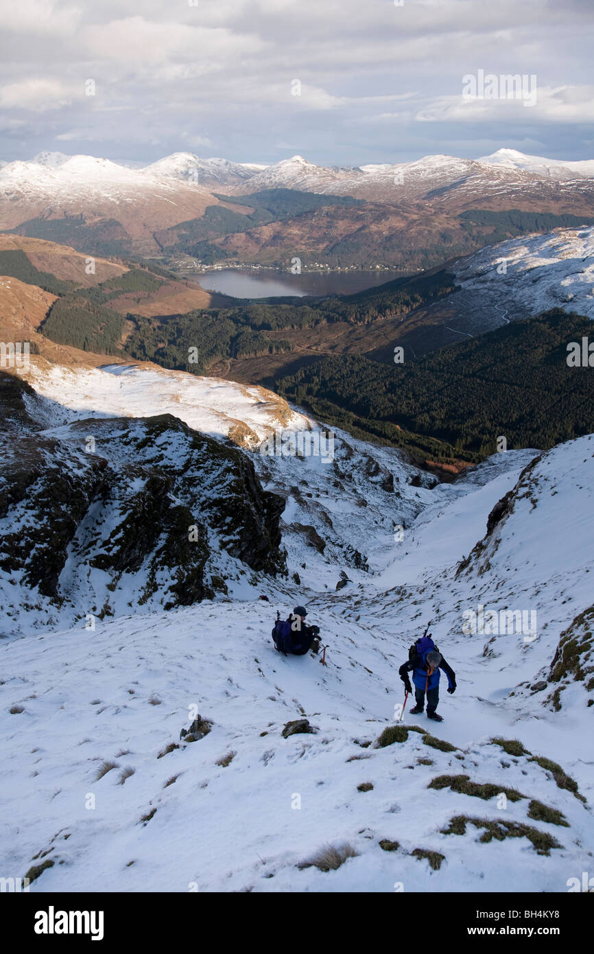 Climbers ascending a snow gully on Beinn Bheula in the Arrochar Alps ...