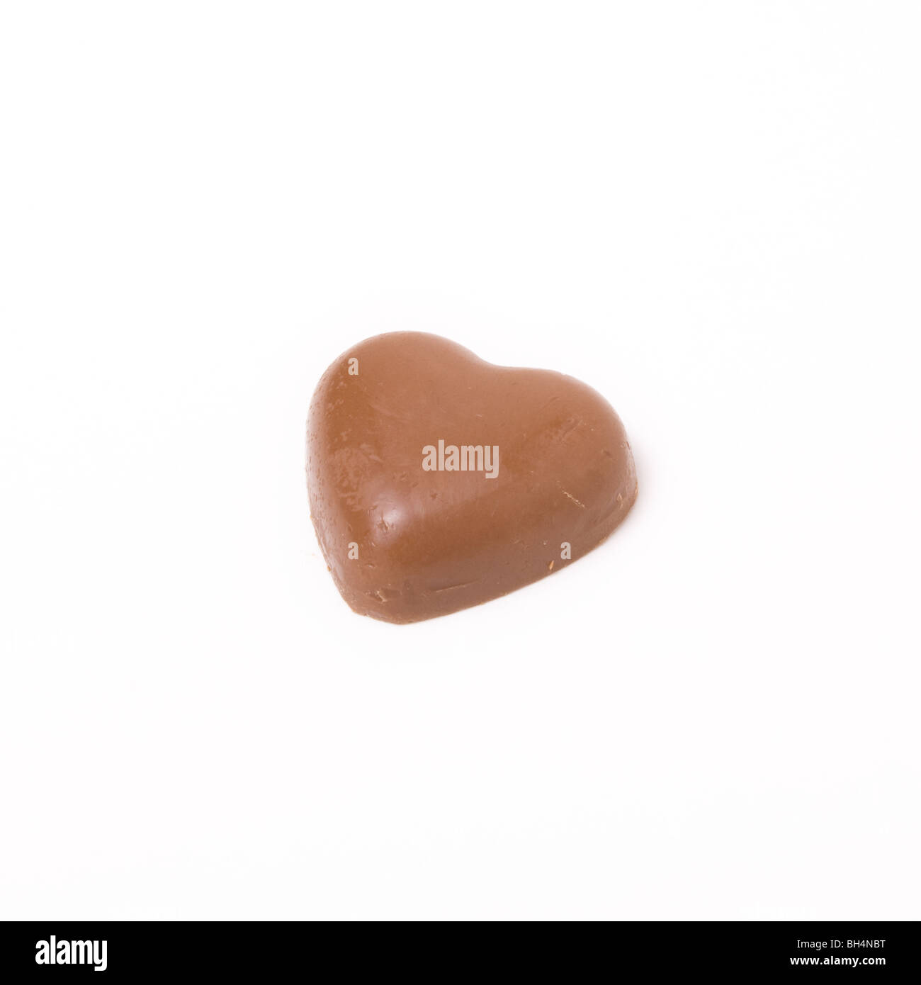 Small milk chocolate heart for valentine's day isolated against white ...