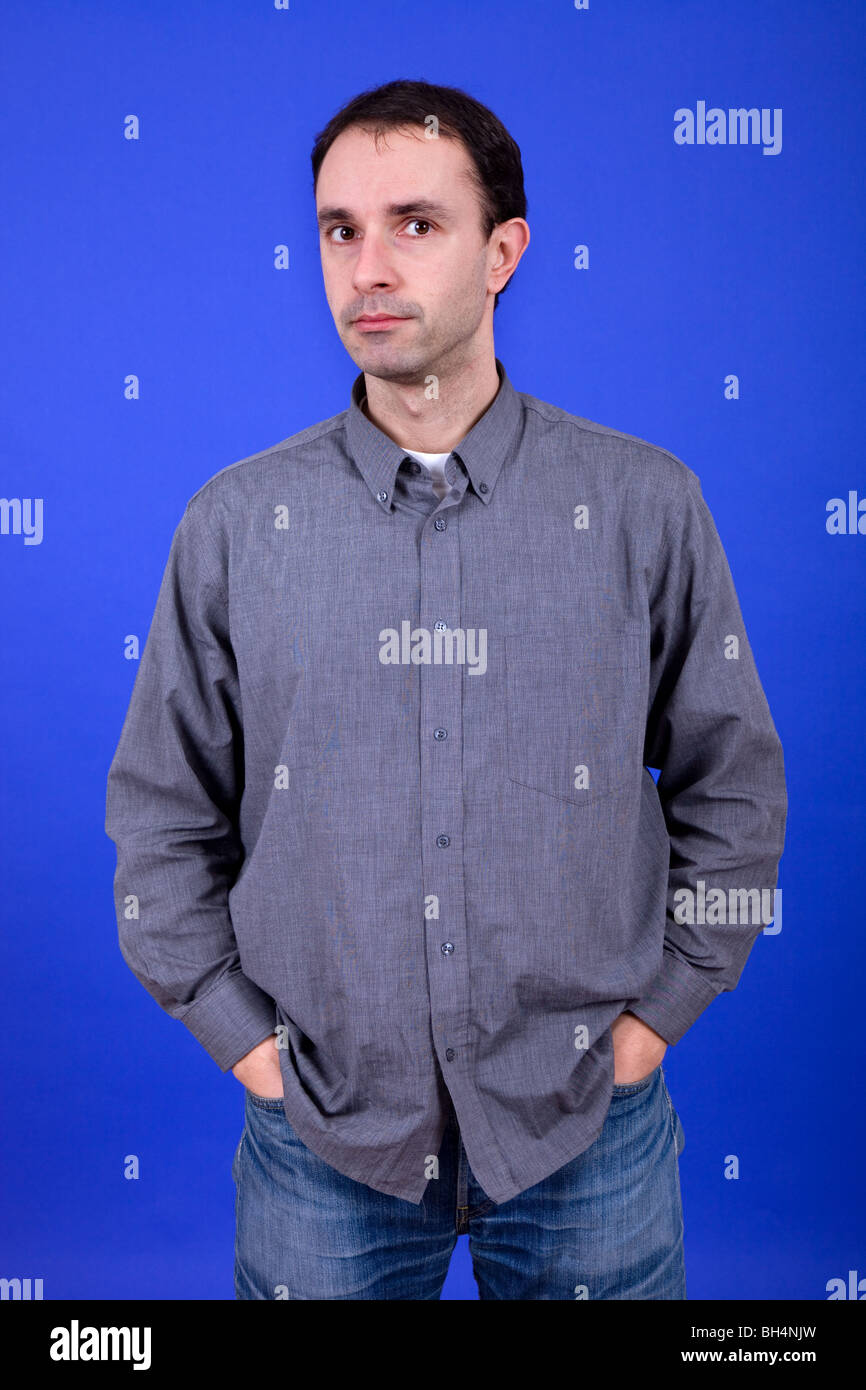 an young man portrait over a blue background Stock Photo - Alamy