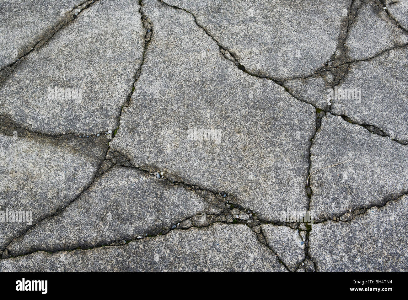 Cracks in concrete pavement Stock Photo - Alamy