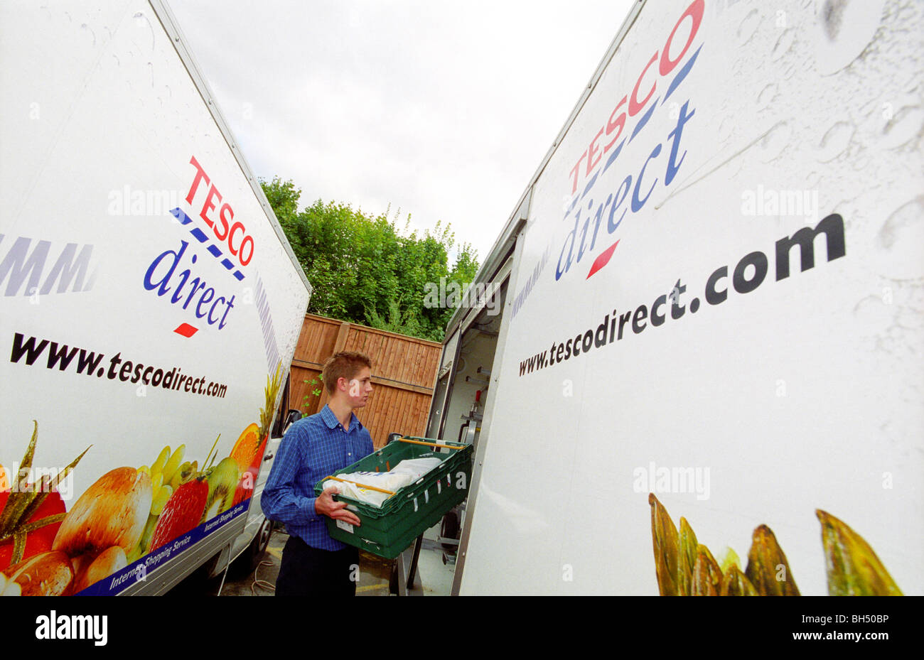Tesco Direct delivery van being loaded up with groceries at a store ...