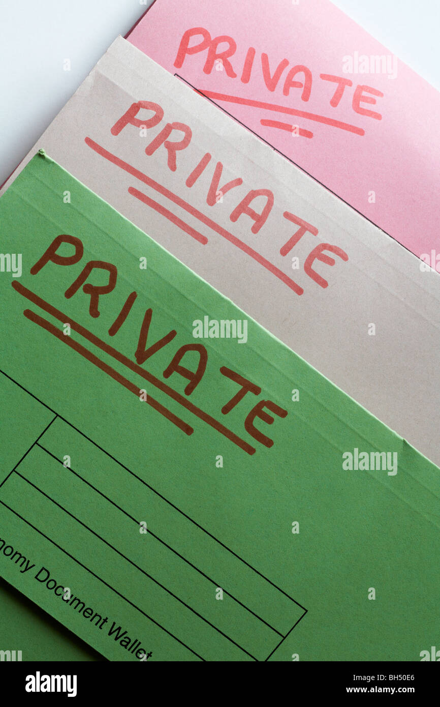 pink green and buff folders document wallets marked private Stock Photo ...