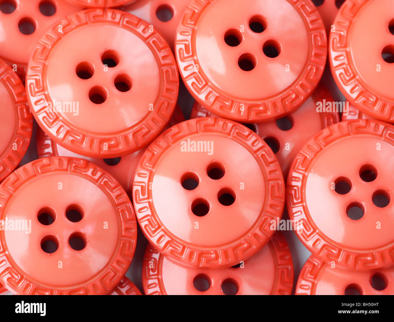 Pile of identical apparel round orange buttons shot from above Stock ...