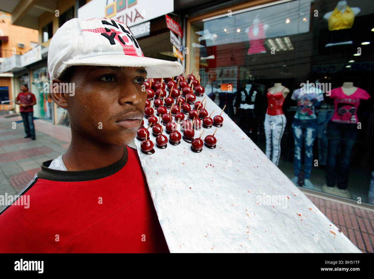 A young man sells candies on the street, Zona Colonial, Santo Domingo ...