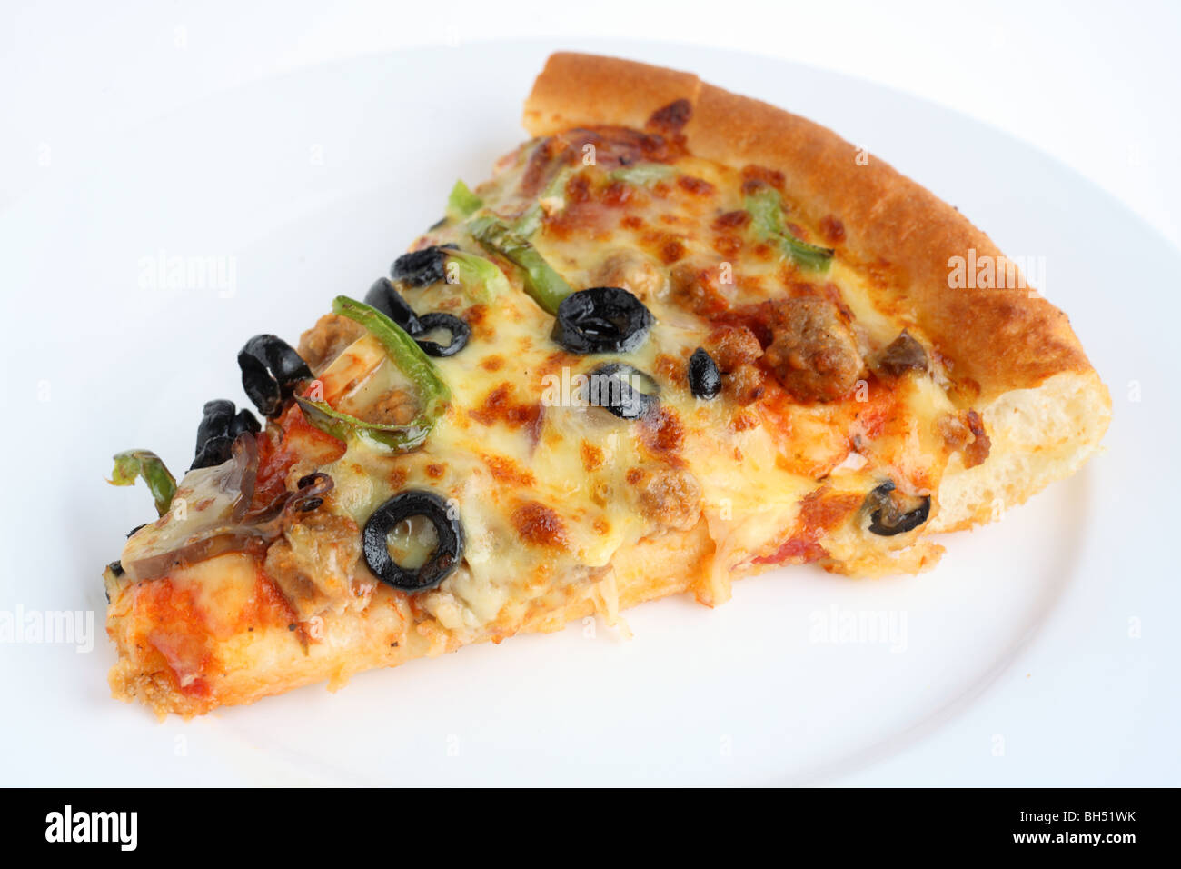 A slice of "supreme" pizza with a full set of toppings - cheese, tomato ...