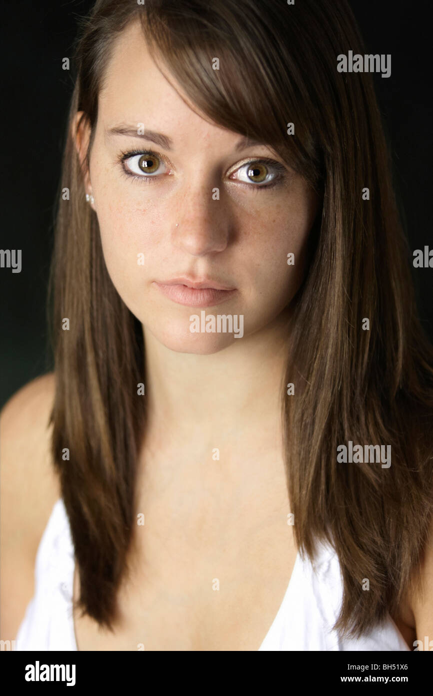A young girl alone smiling and happy Stock Photo - Alamy