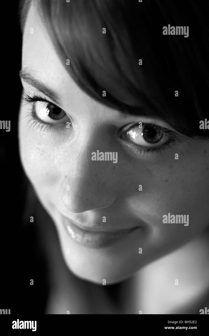 A young girl alone smiling and happy Stock Photo - Alamy