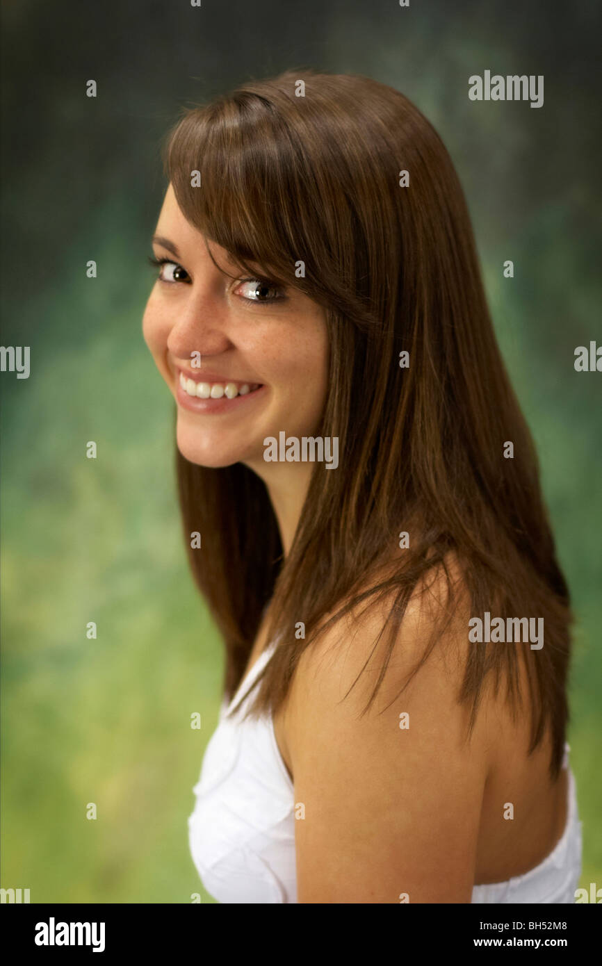 A young girl alone smiling and happy Stock Photo - Alamy