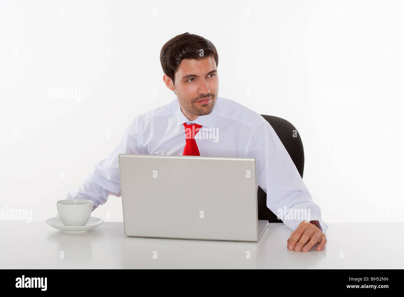 young business executive in white shirt behind desk with laptop Stock ...