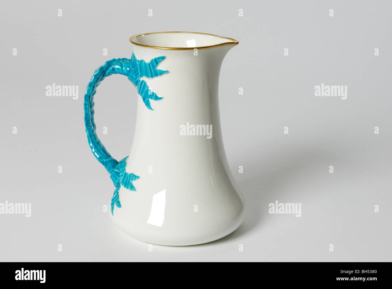 An antique English china jug with gilded rim and ribbon handle, circa ...