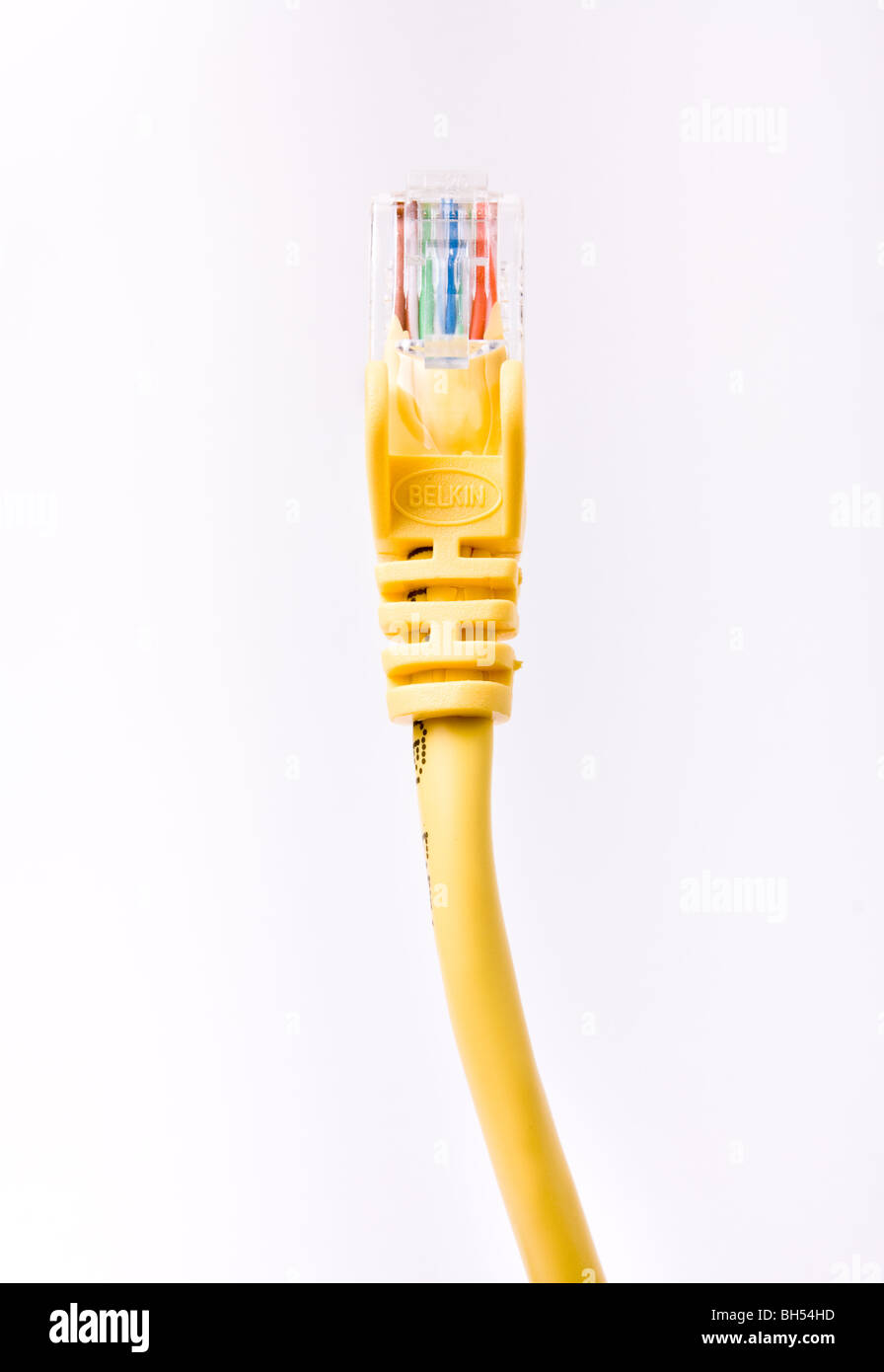Yellow Network Cable with molded RJ45 plug isolated against white ...
