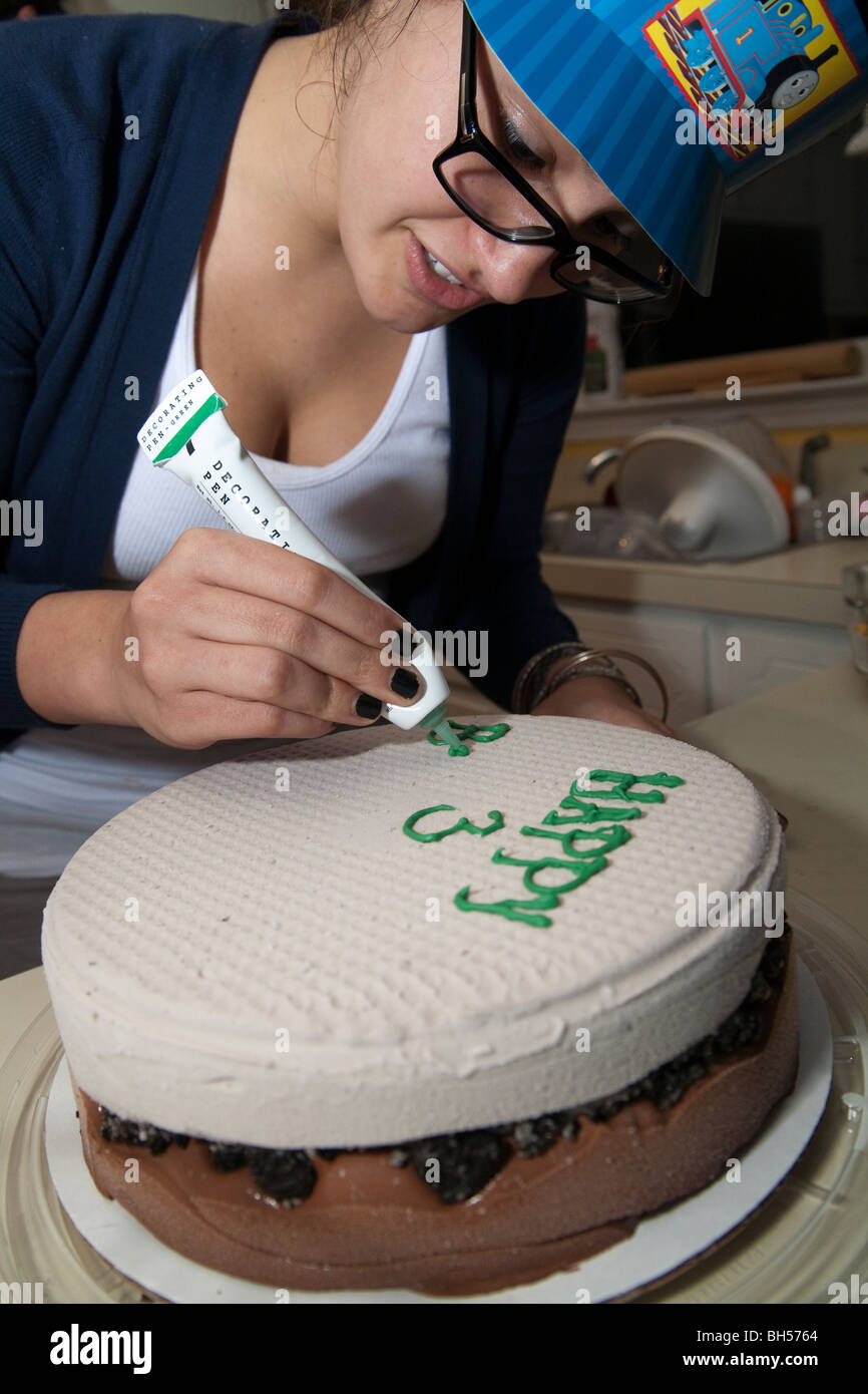 Woman decorating top cake hi-res stock photography and images - Alamy